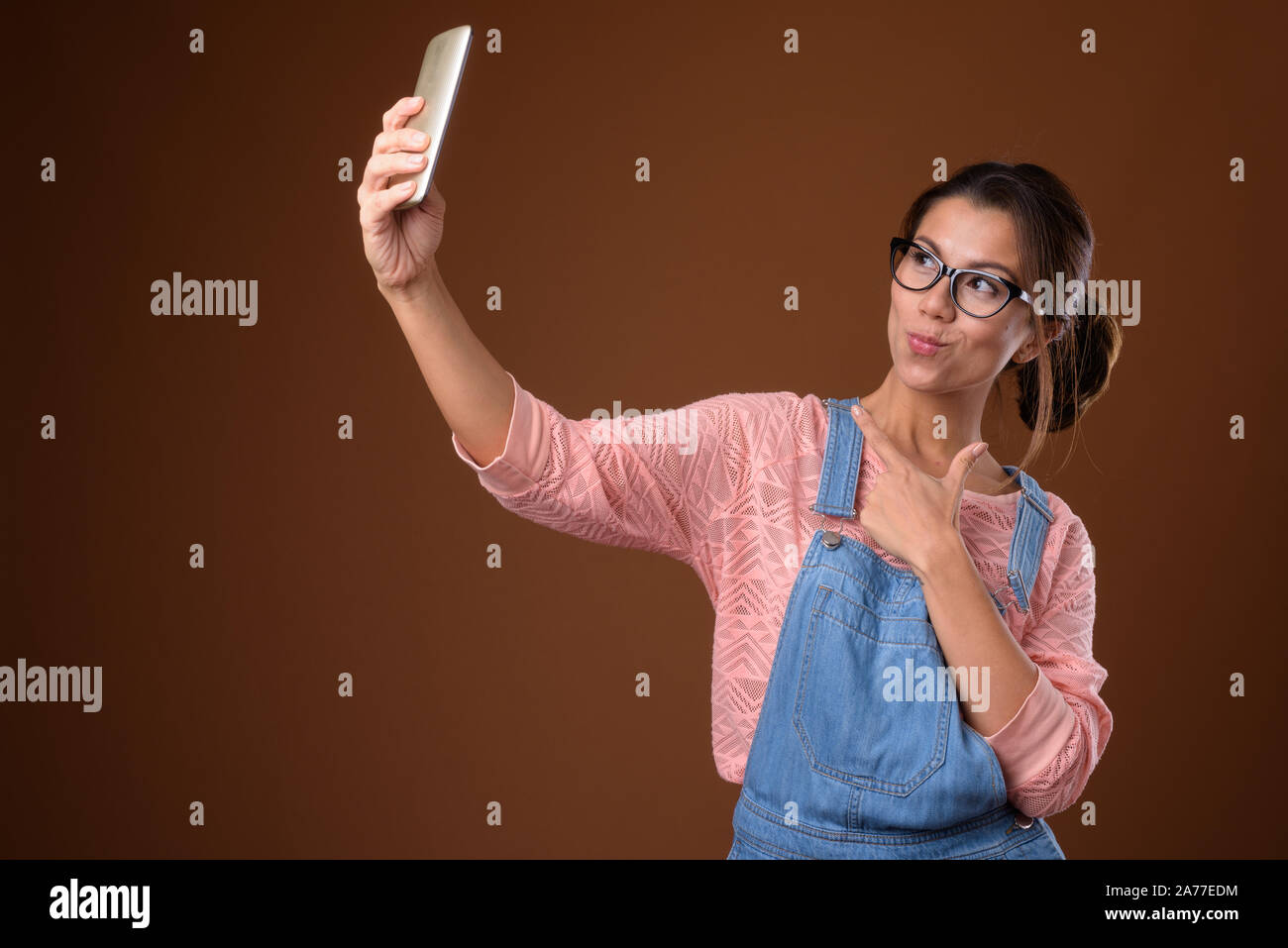 Portrait of beautiful multi ethnic nerd woman using phone Stock Photo ...