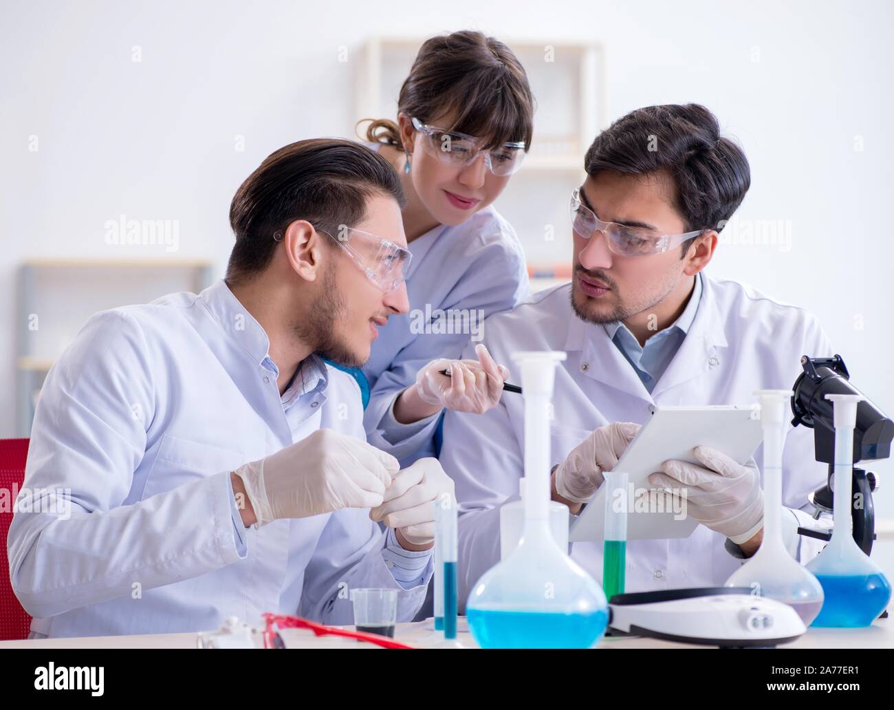 The team of chemists working in the lab Stock Photo - Alamy