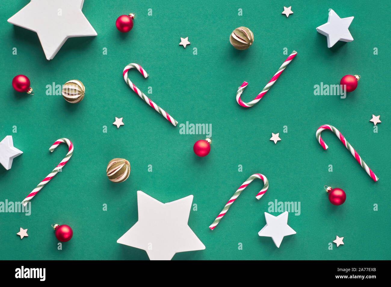 Creative Christmas flat lay with candy canes, red glass baubles and dry ...