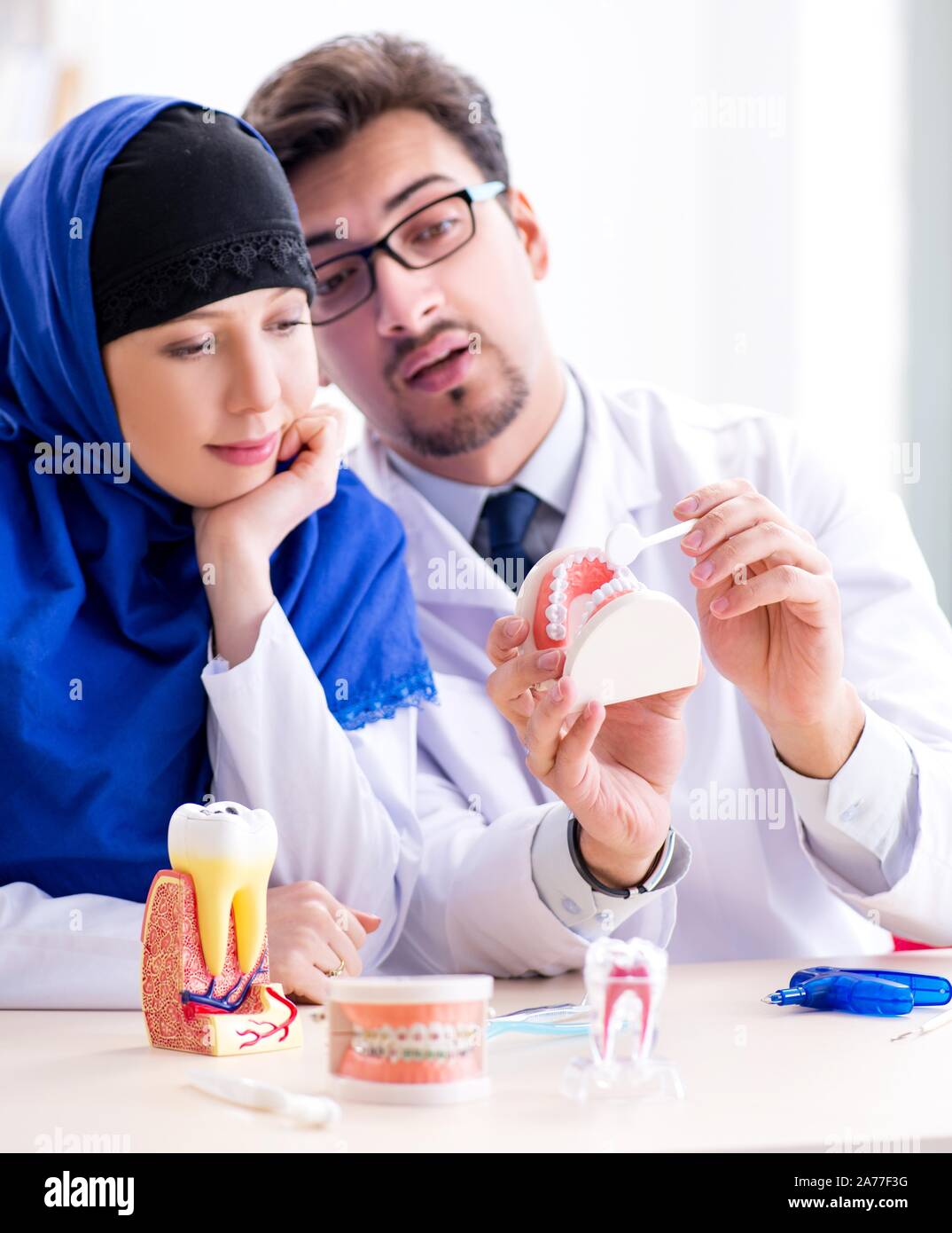 The dentist doctor and assistant working on new tooth implant Stock ...