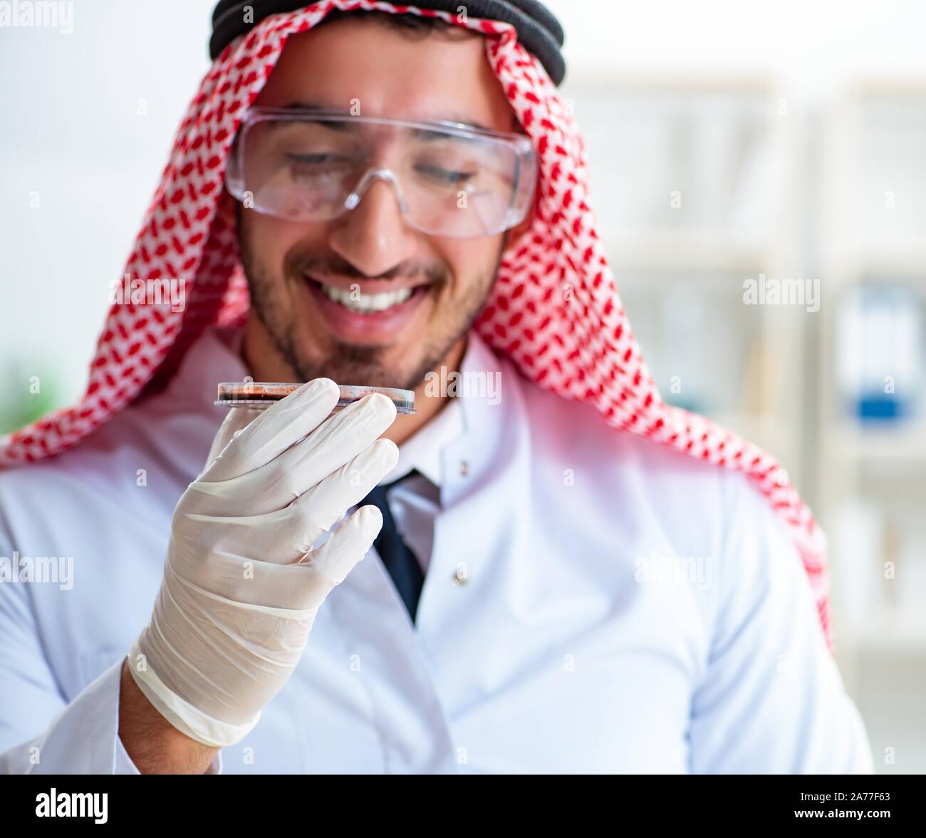 The arab chemist working in the lab office Stock Photo - Alamy