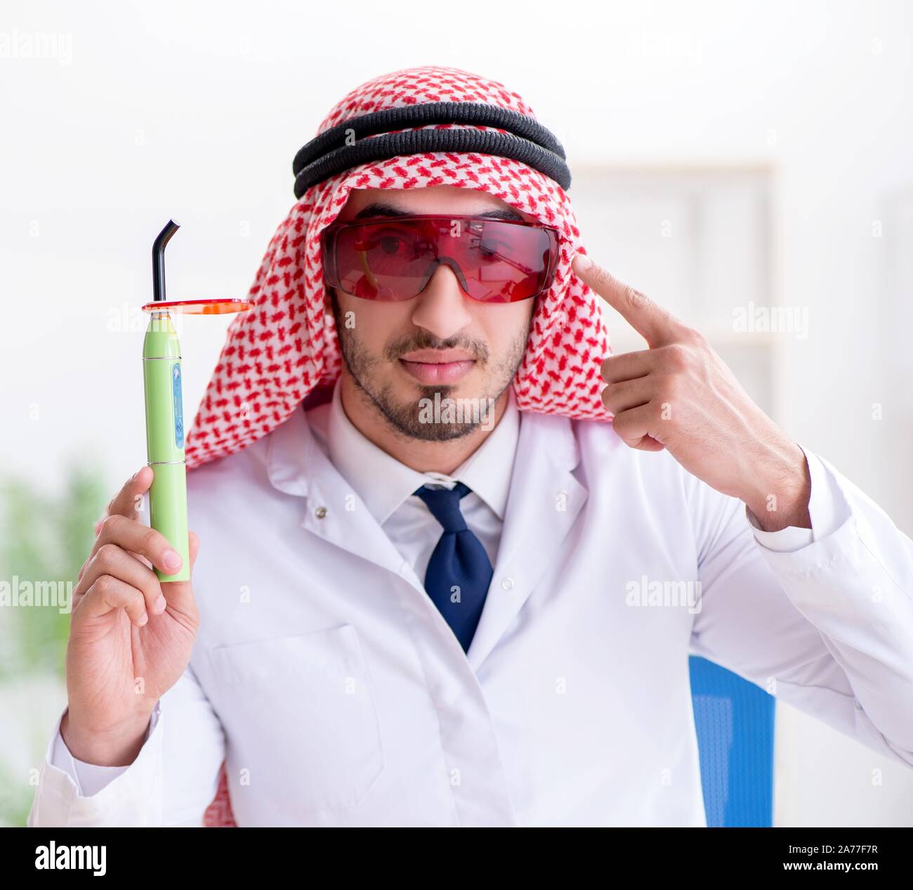 The arab dentist working on new teeth implant Stock Photo - Alamy