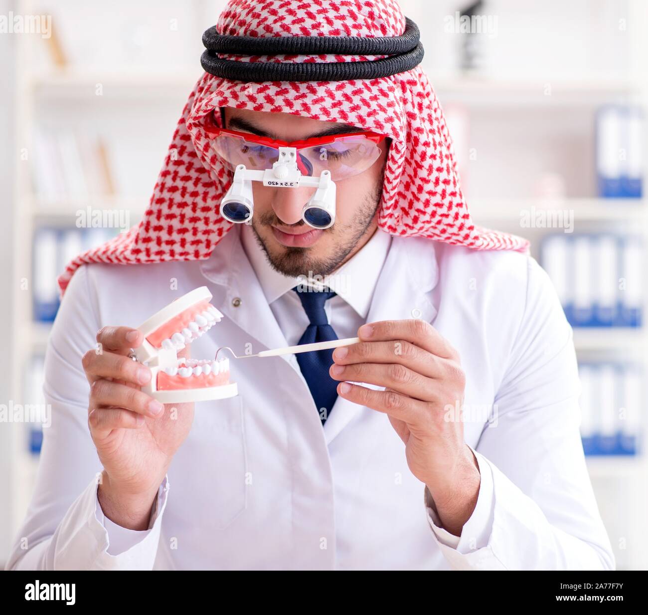 The arab dentist working on new teeth implant Stock Photo - Alamy