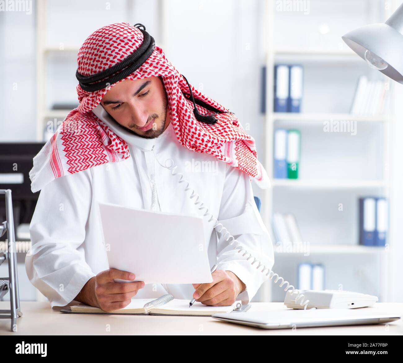 The arab businessman working in the office Stock Photo - Alamy
