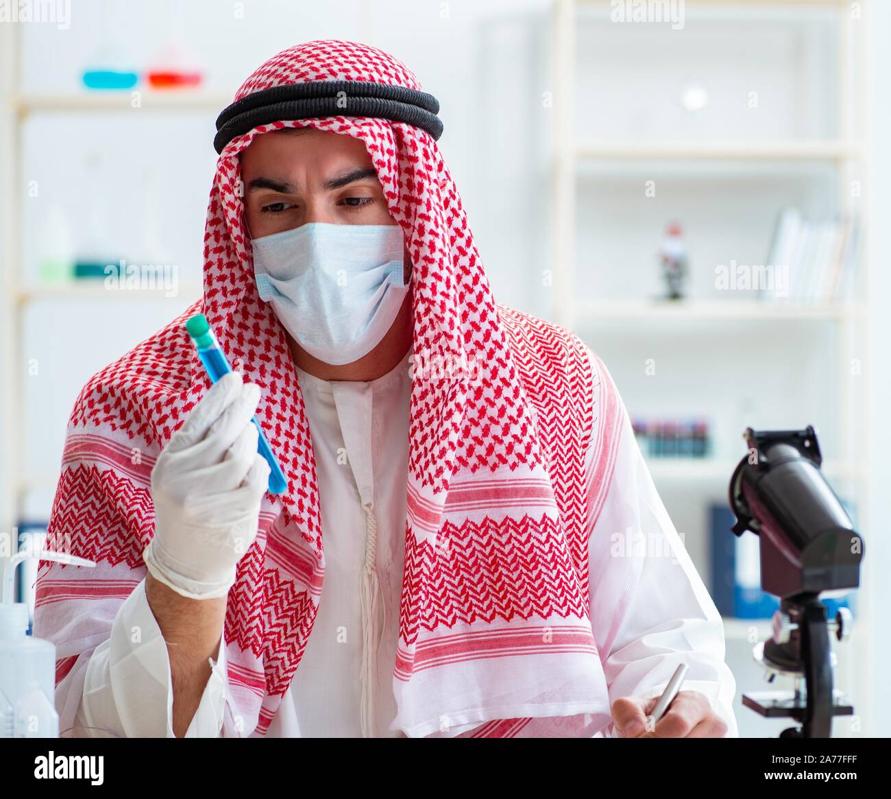 The arab chemist working in the lab office Stock Photo - Alamy