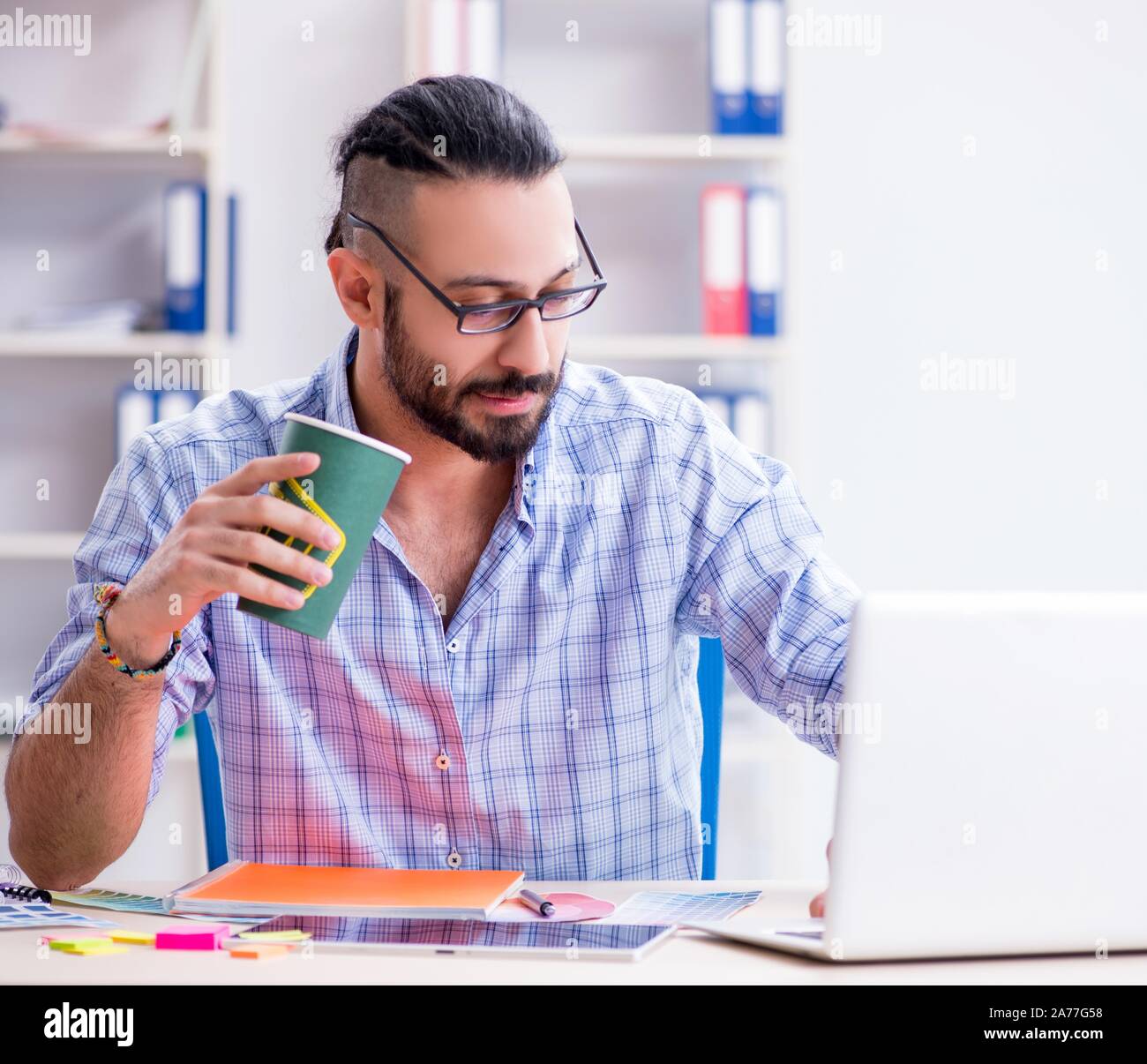 The young designer working in his studio on new project Stock Photo - Alamy