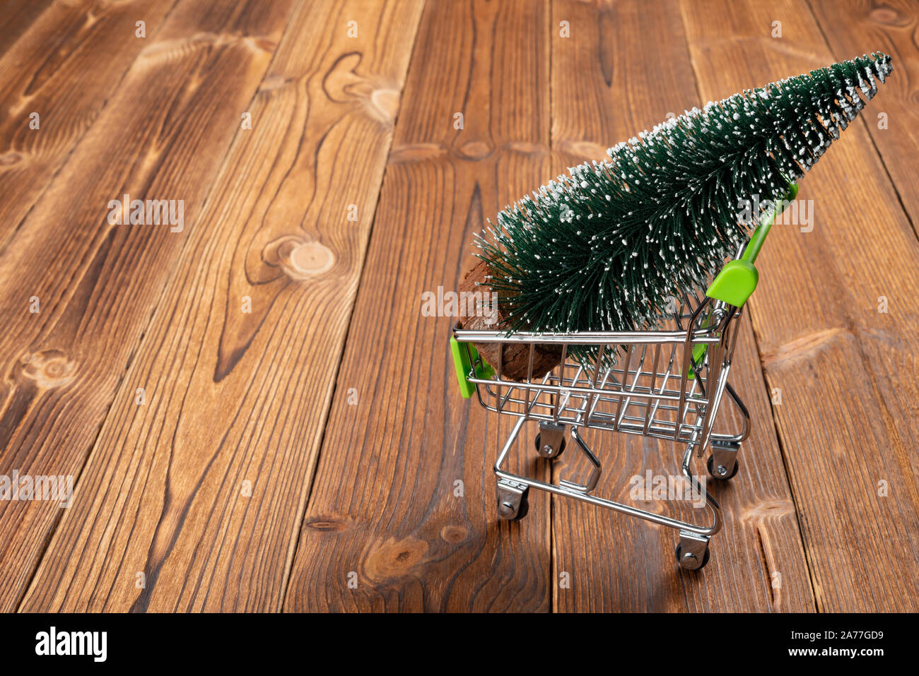 shopping cart with Christmas fir tree on a wood table Stock Photo - Alamy