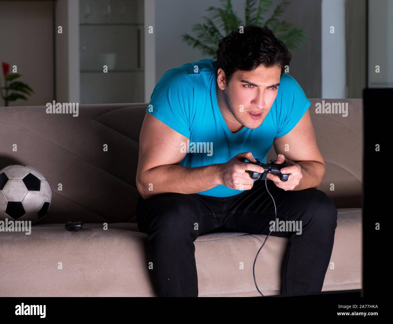 The young man playing computer games late at night Stock Photo - Alamy