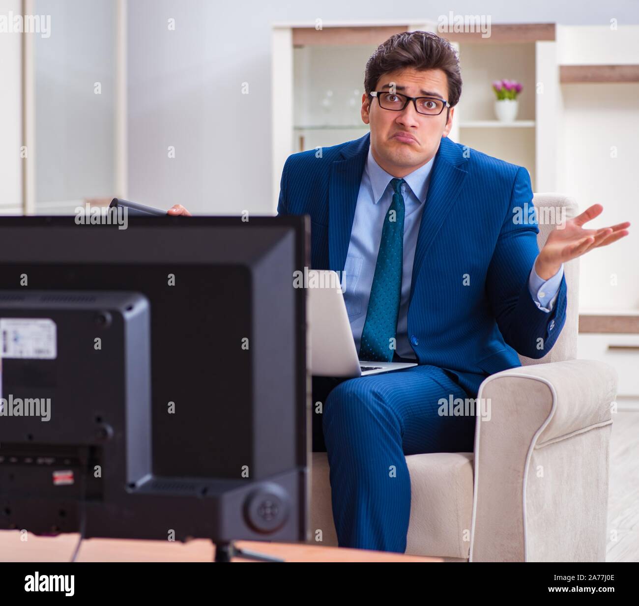 The businesman watching tv in office Stock Photo - Alamy