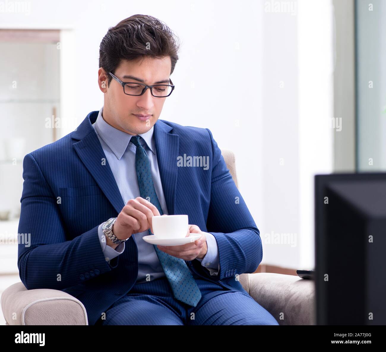 The businessman watching tv in the office Stock Photo - Alamy