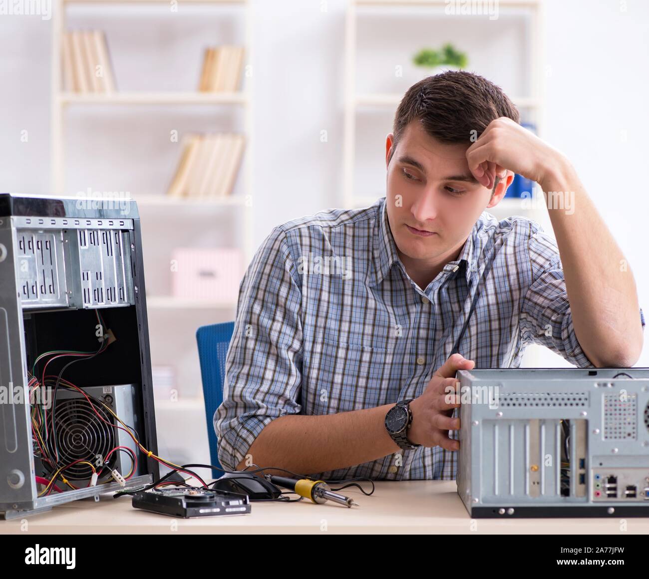 The young technician repairing computer in workshop Stock Photo - Alamy