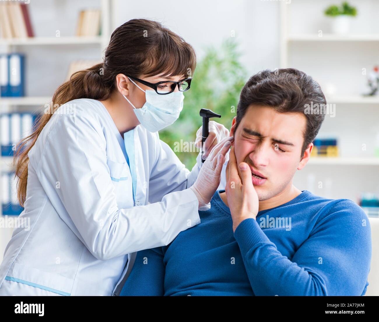The doctor checking patients ear during medical examination Stock Photo ...