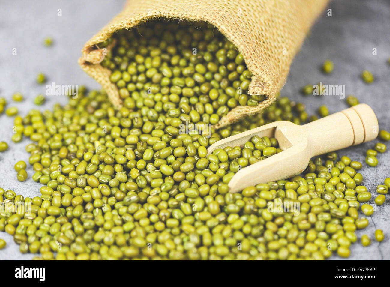 Green mung beans in the sack with wooden scoop / Mung bean seed cereal ...
