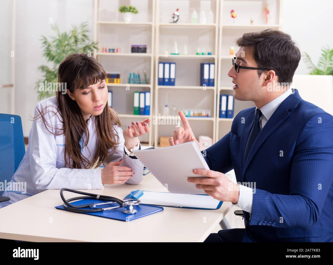 The man signing medical insurance contract Stock Photo - Alamy