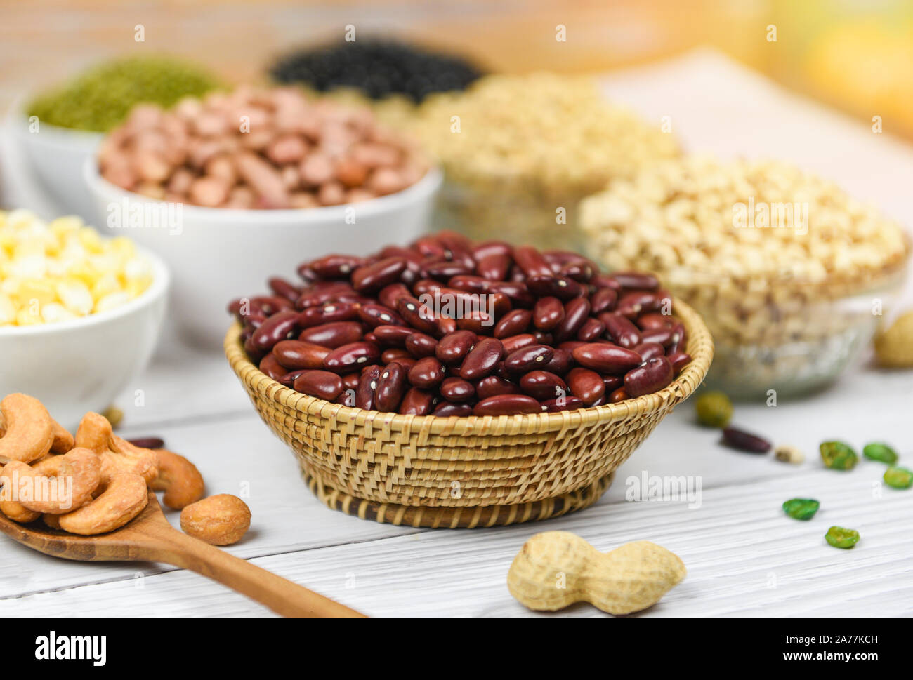 Different whole grains red beans and legumes seeds lentils and nuts ...