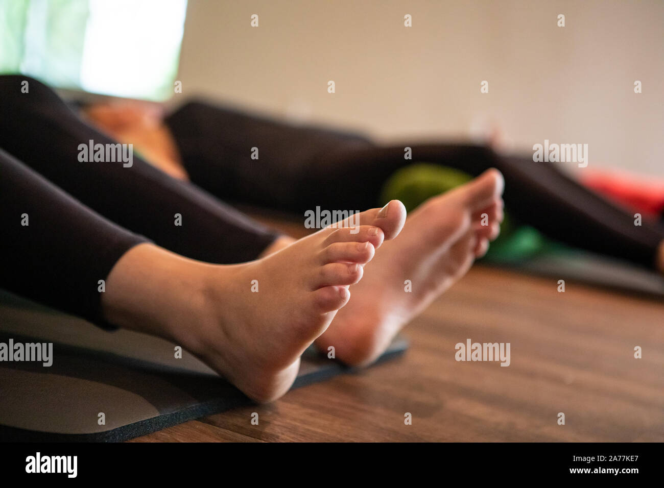 Selective photo of a group of students sitting on yoga mats on the ...