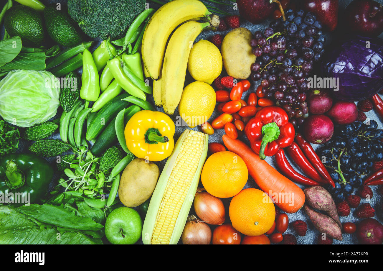 Assorted fresh ripe fruit red yellow purple and green vegetables mixed ...