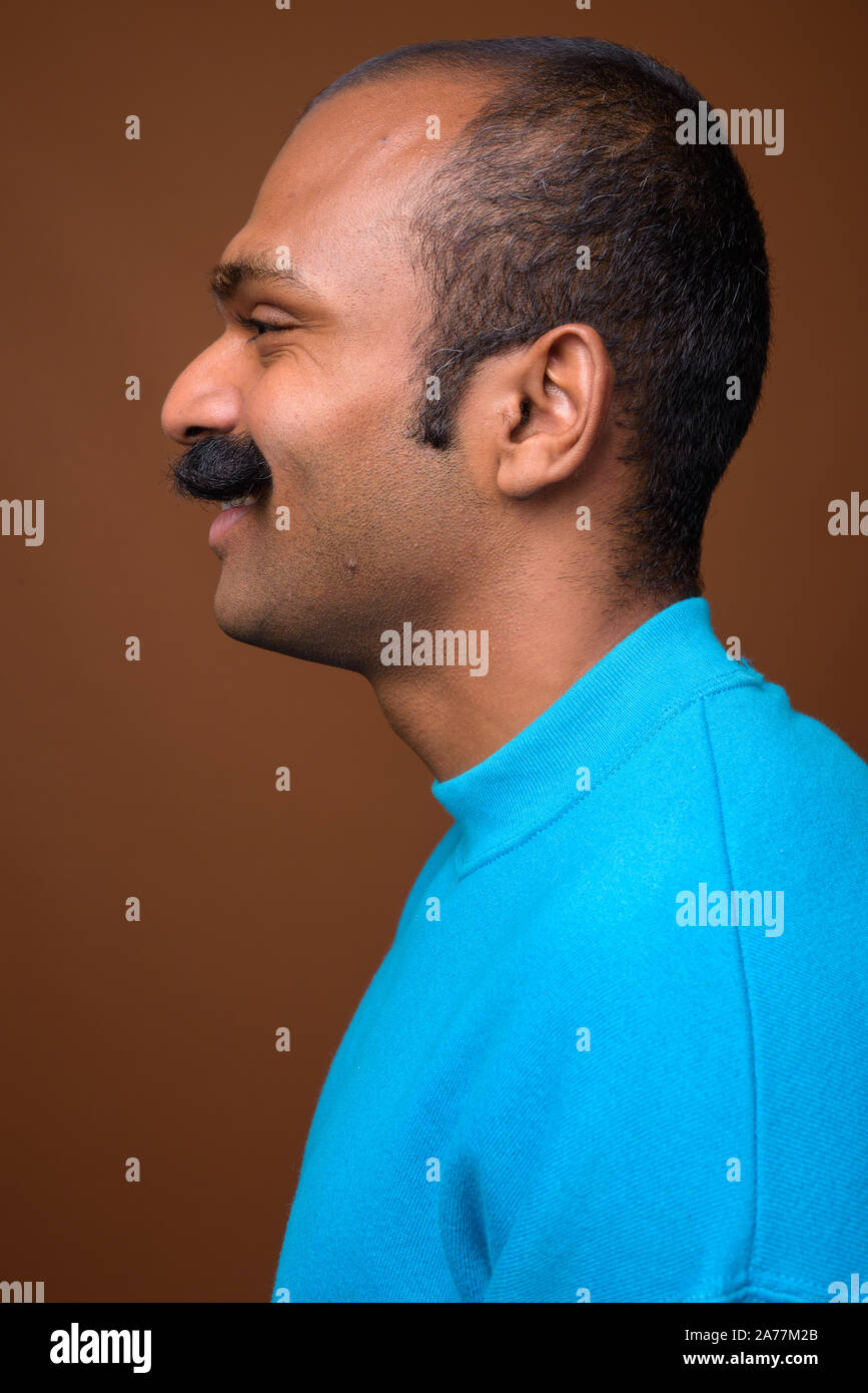 Closeup profile view of happy Indian man with mustache wearing blue ...