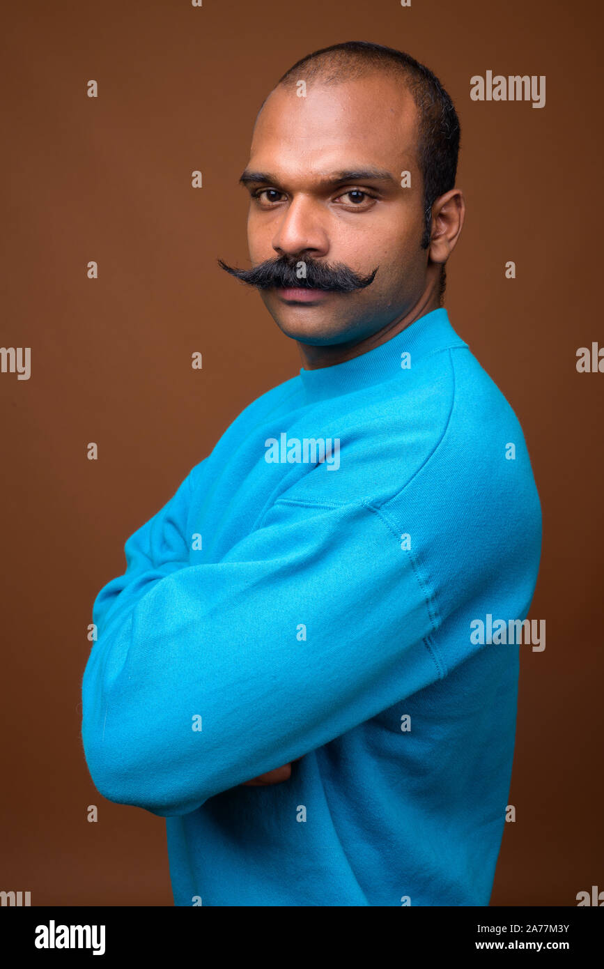 Portrait of Indian man with mustache wearing blue sweater Stock Photo ...
