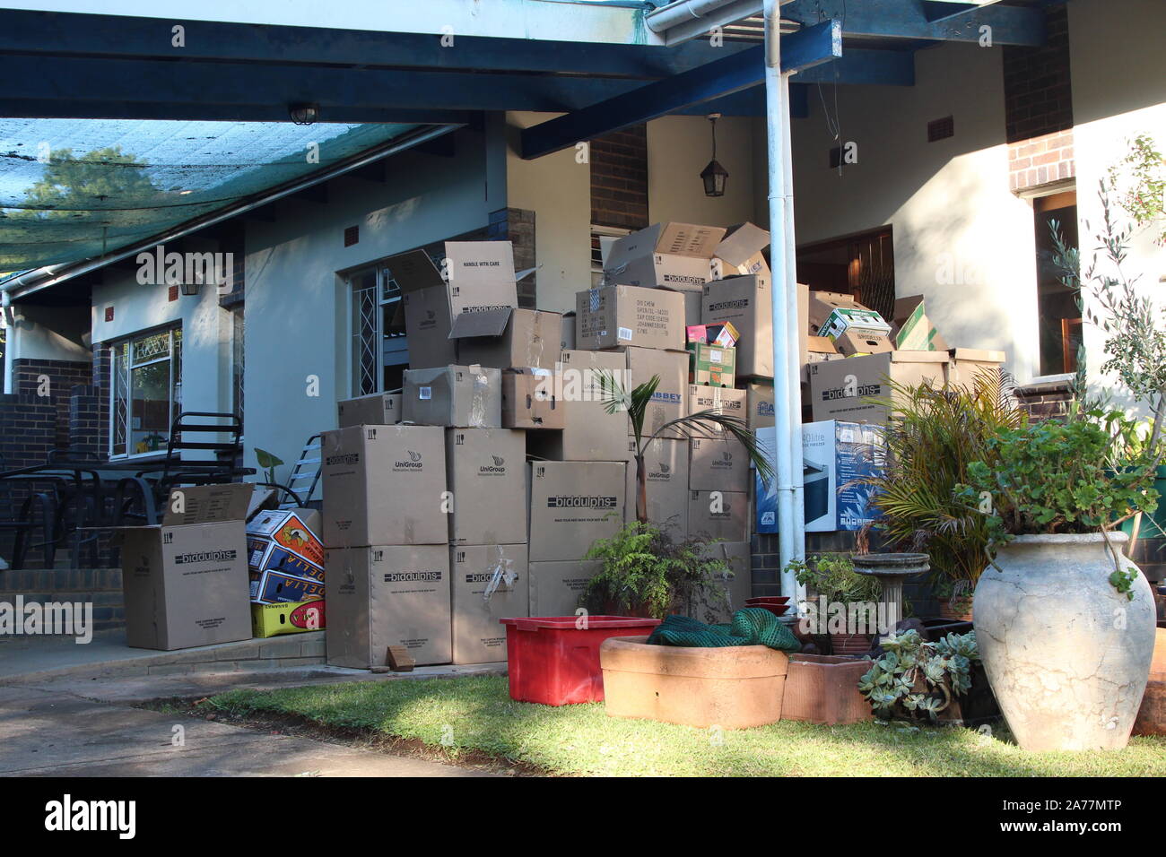 Moving Day Boxes stacked, ready to be carried into the house and ...