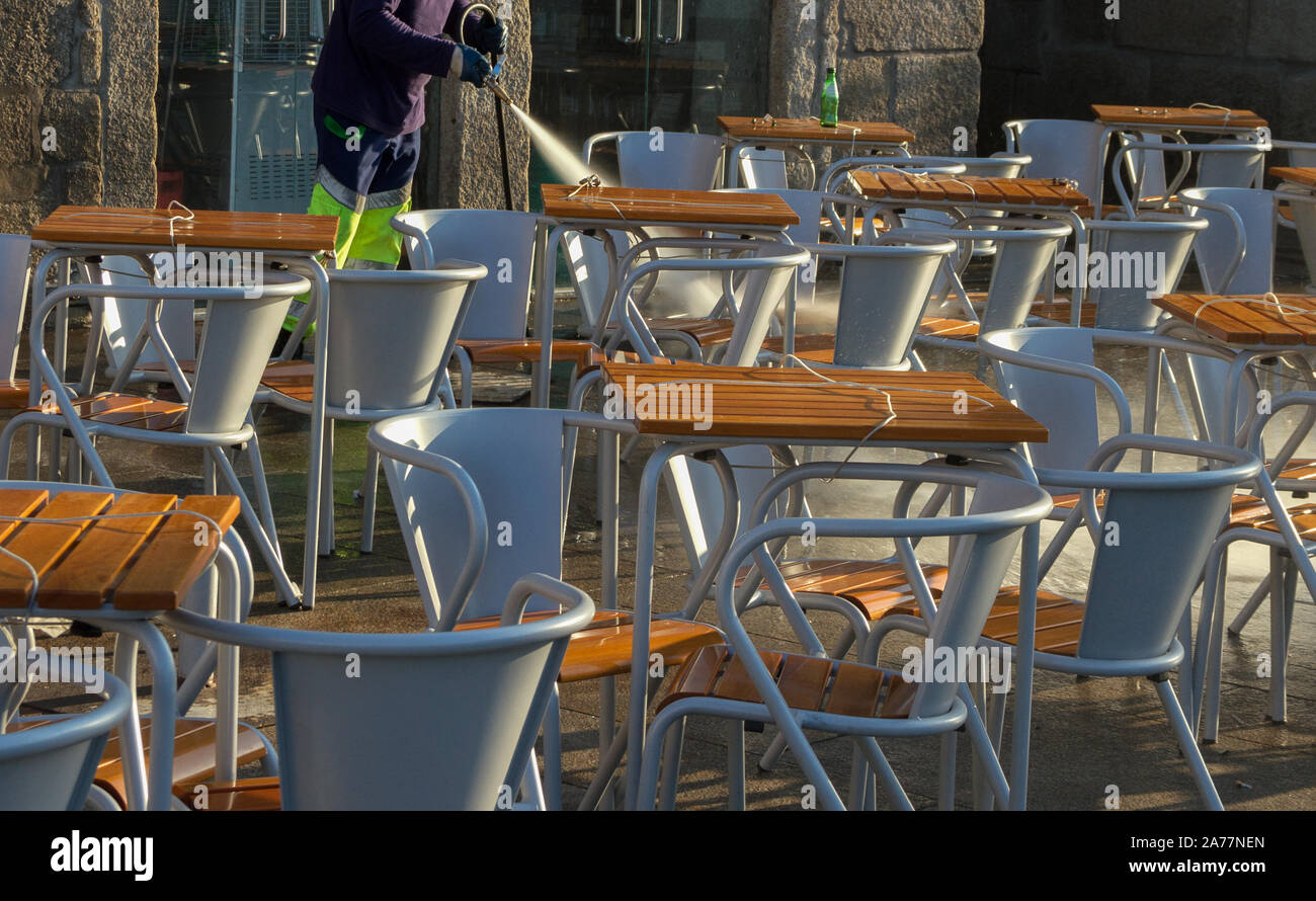 Wet cleaning floor of street cafe with pressurized water Stock Photo ...