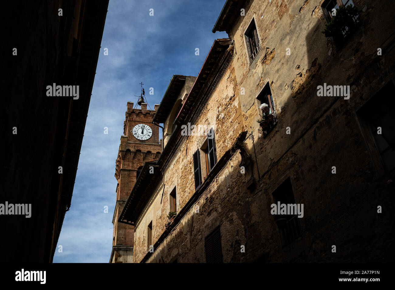Old clock tower in a medieval town skyline in Tuscany, Italy Stock ...
