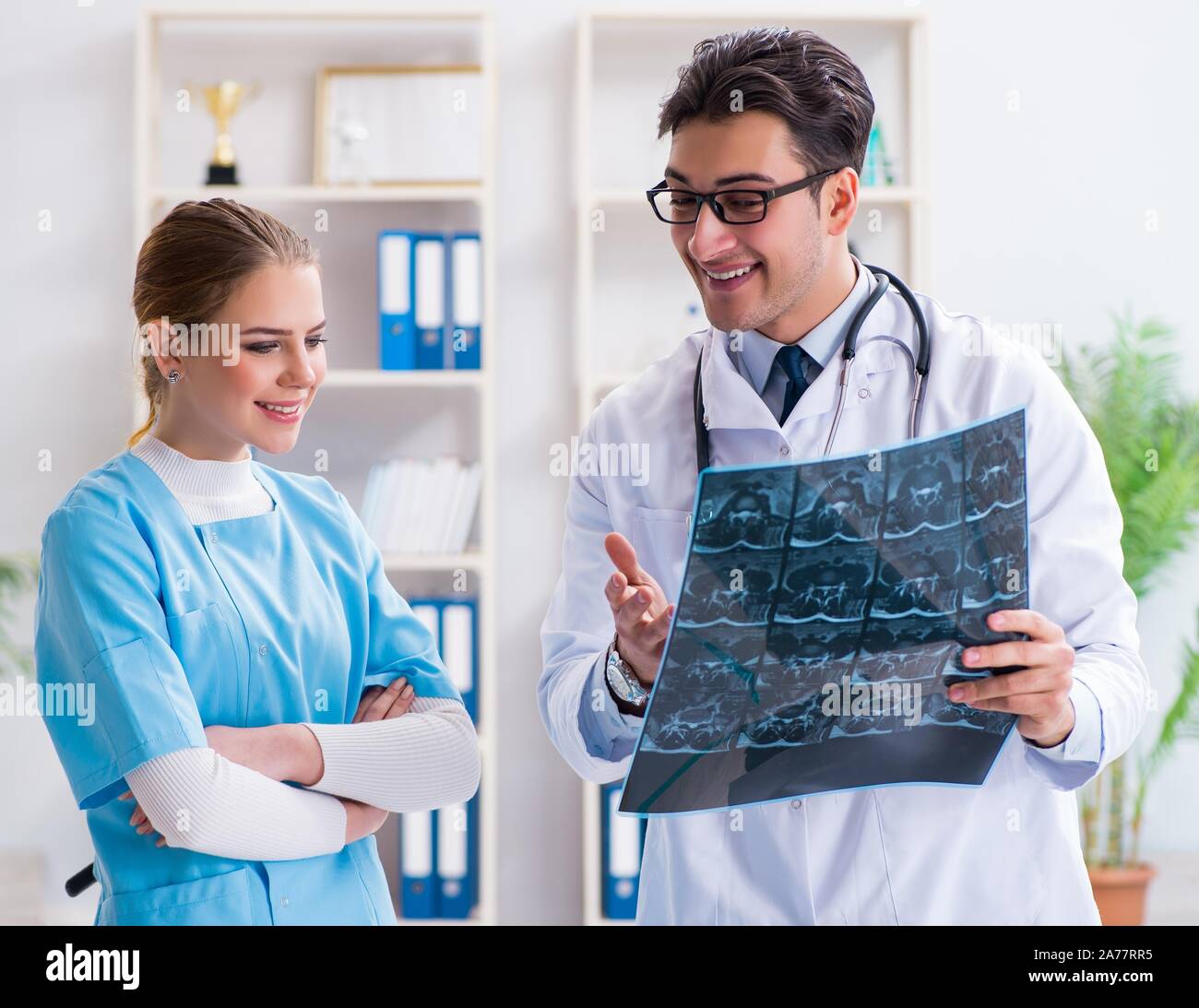 The two doctors examining x-ray images of patient for diagnosis Stock ...