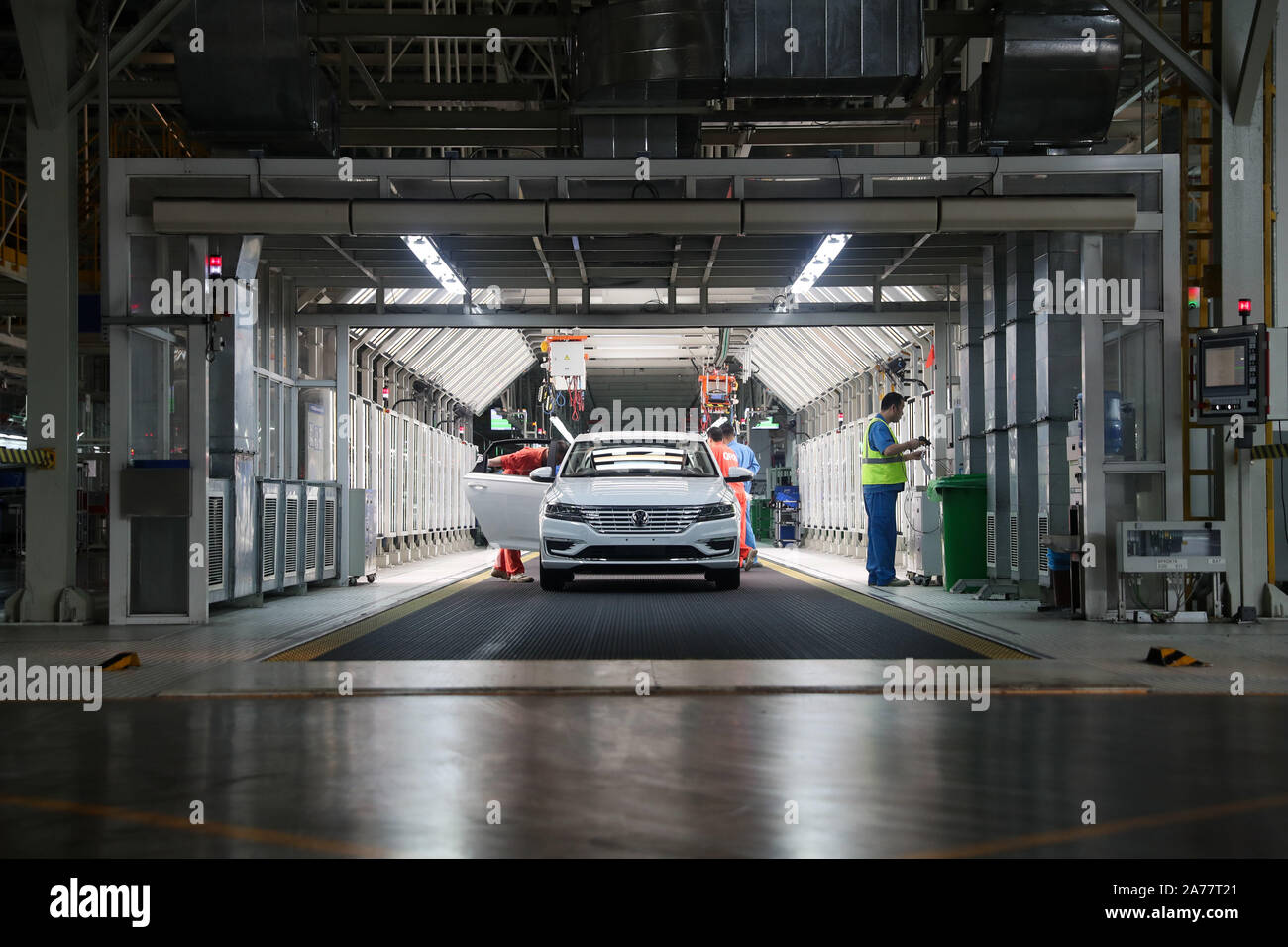 Beijing, China. 29th Oct, 2019. Staff members work at a production line ...