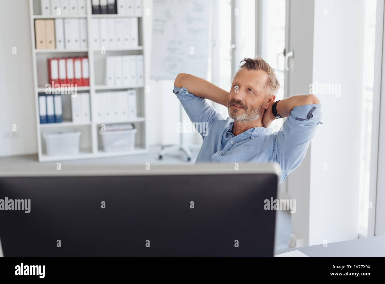 Businessman desk office leaning back hi-res stock photography and ...