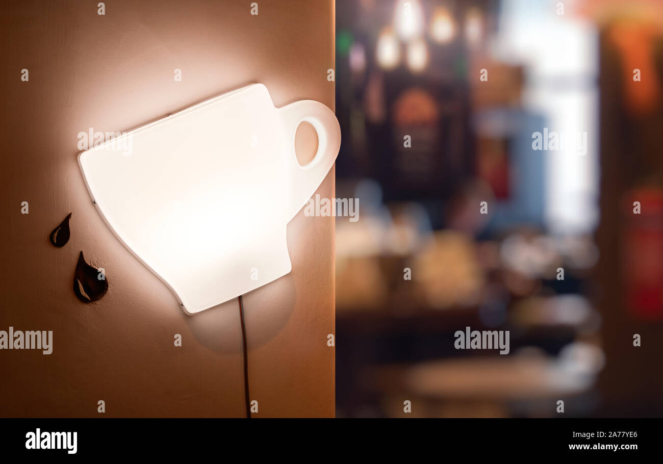Coffee cup wall light with defocus coffee shop or cafeteria background ...