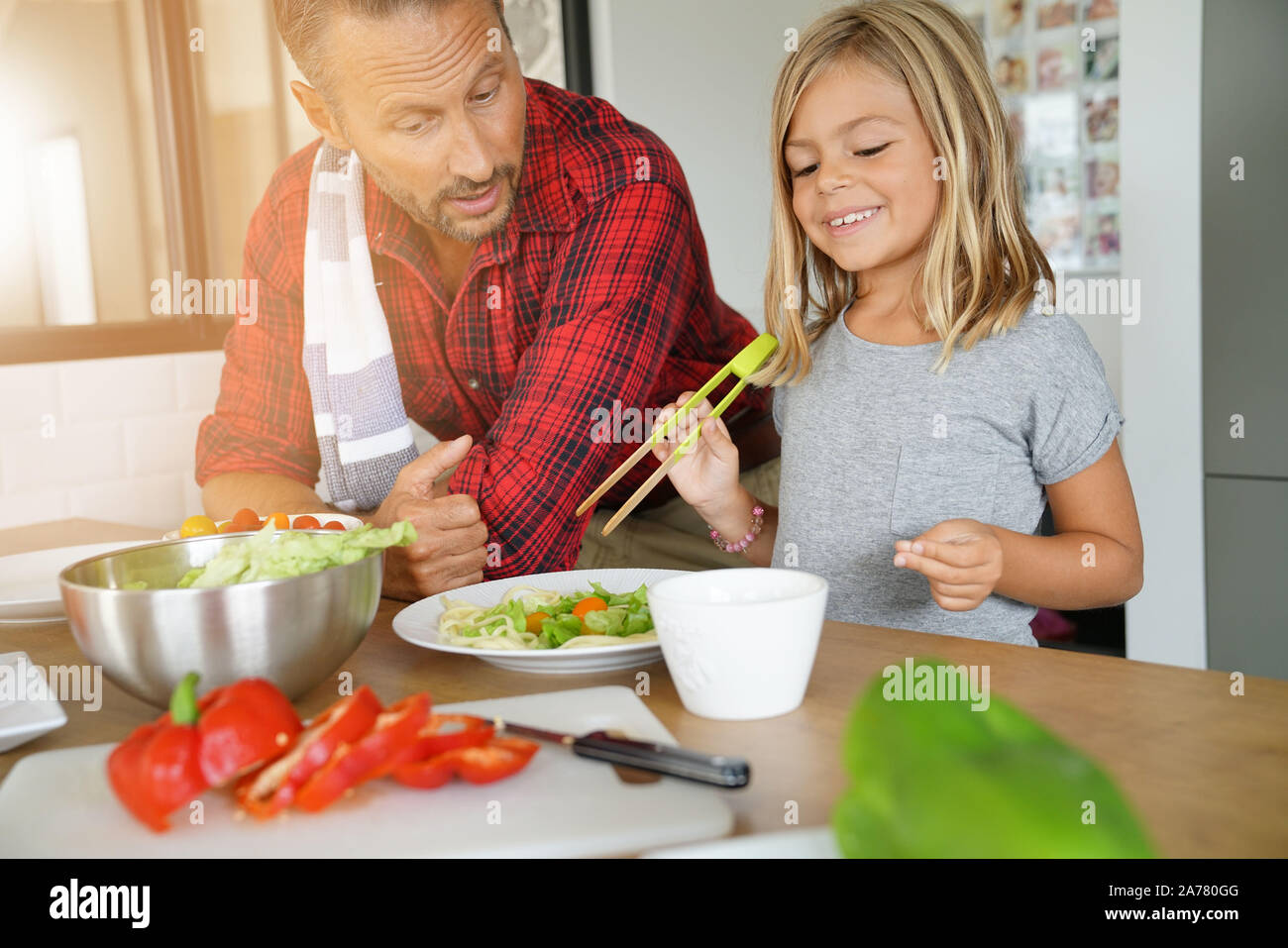 Father and daughter cooking pasta dish together Stock Photo - Alamy