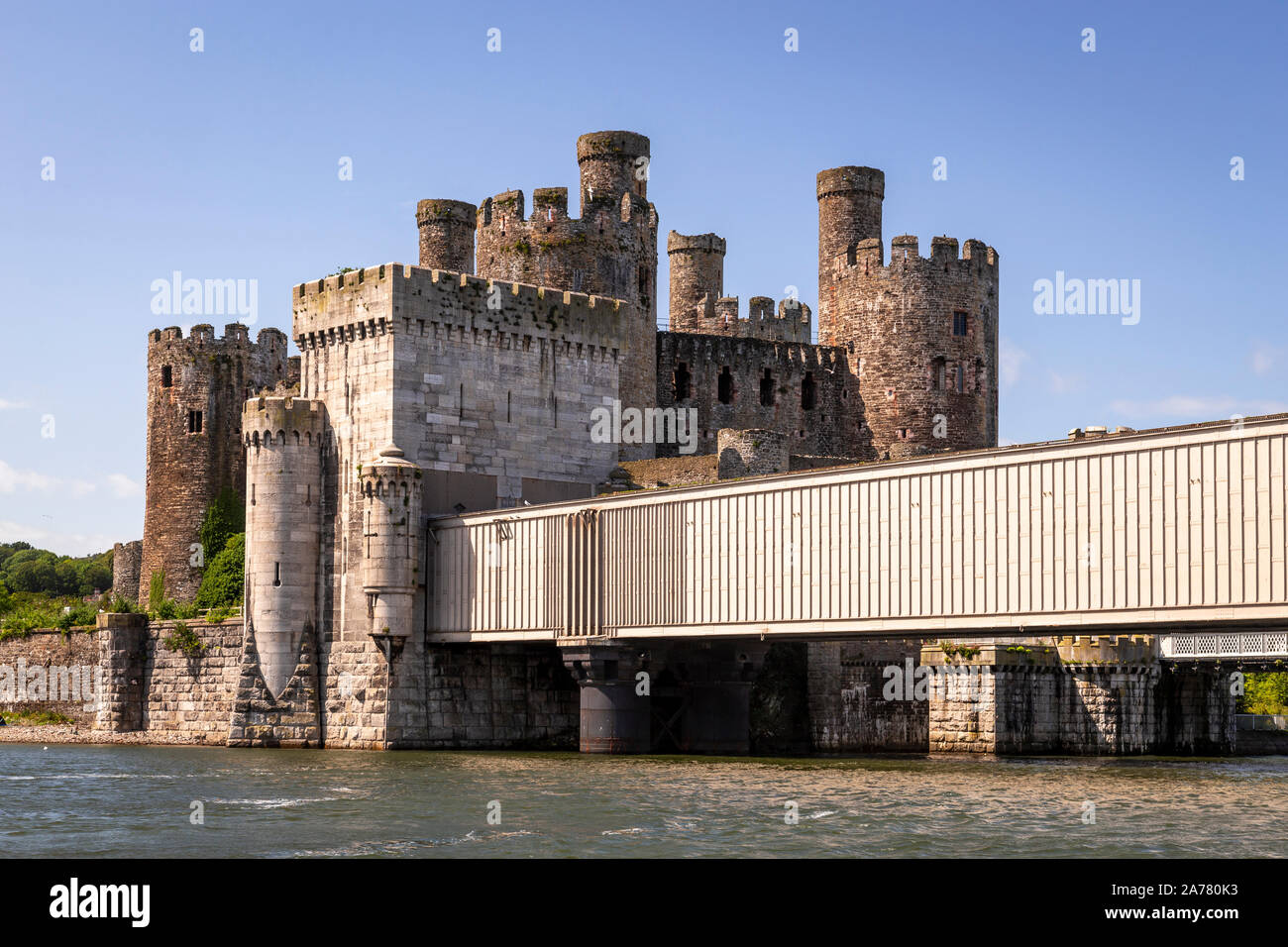 Conway castle and railway bridge from the Conwy estuary, North Wales ...