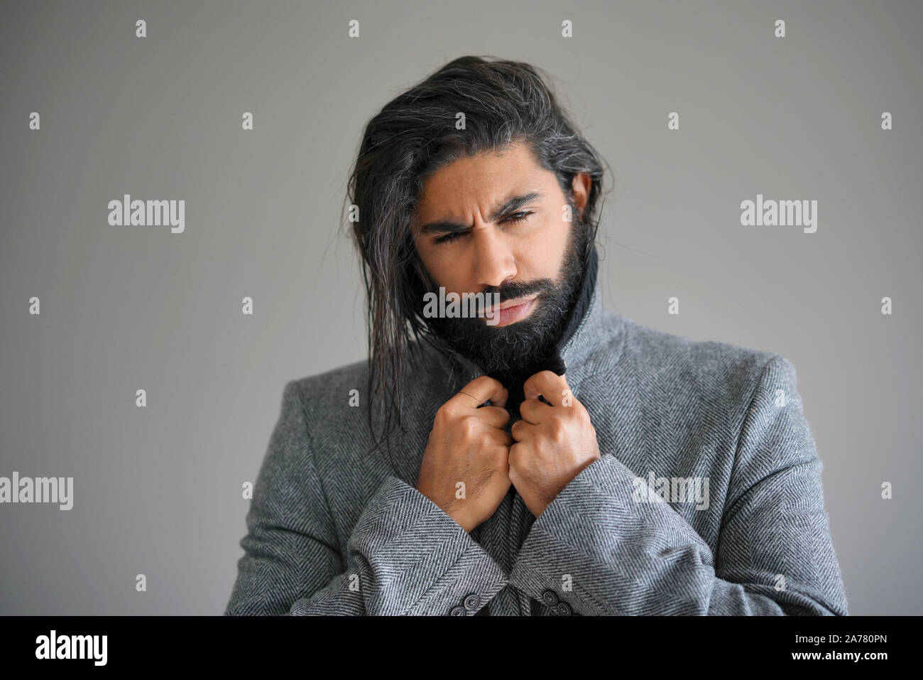 Hipster guy with grey coat, isolated Stock Photo - Alamy