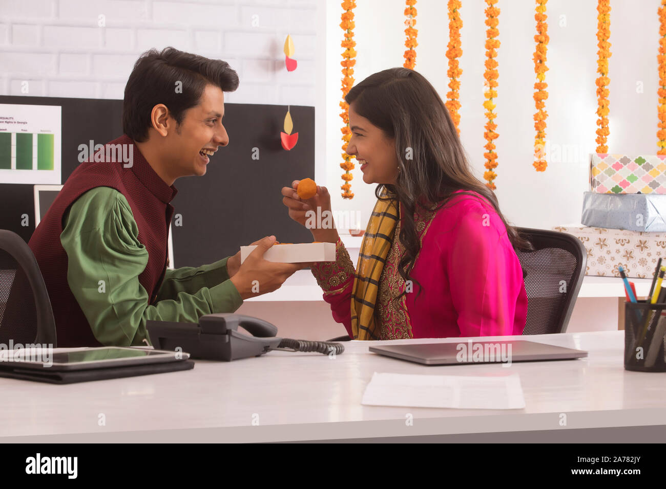 Employees sharing sweets with each other on the occasion of Diwali ...