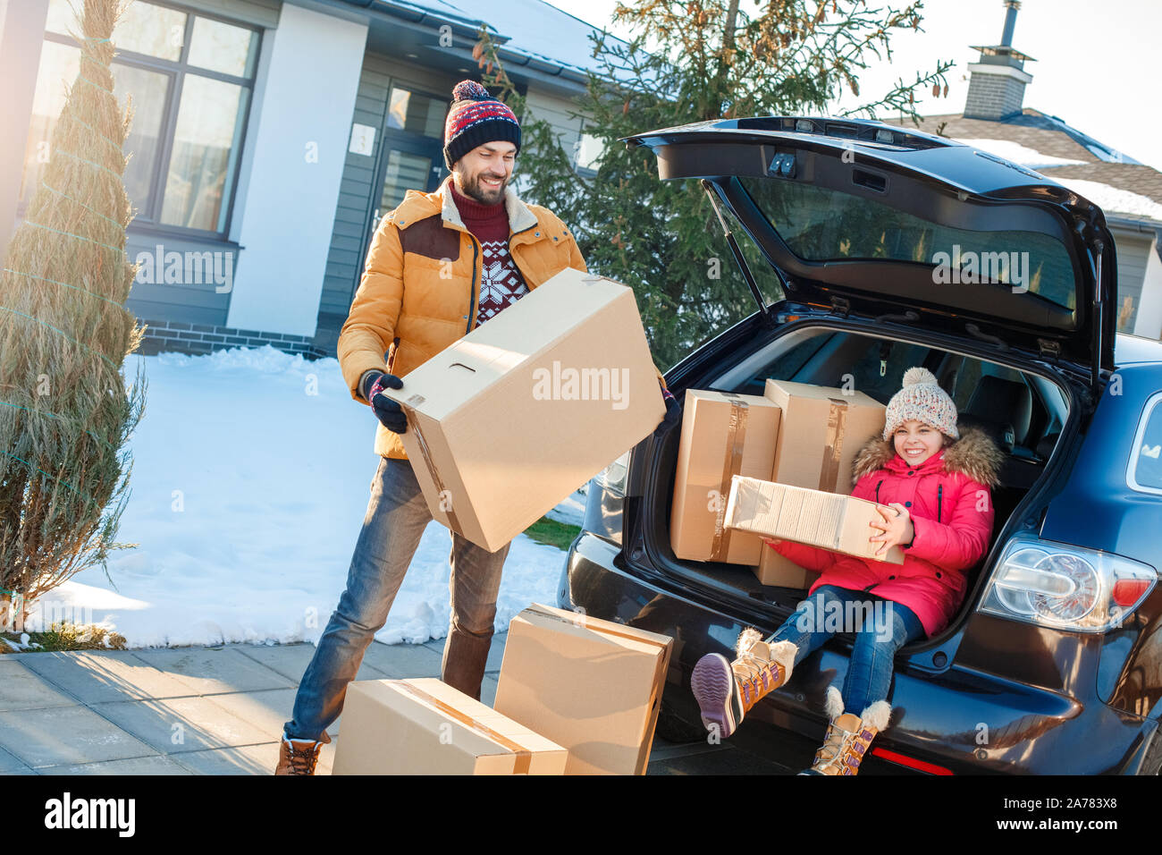 Moving to new apartment. Family together outdoors standing near car ...
