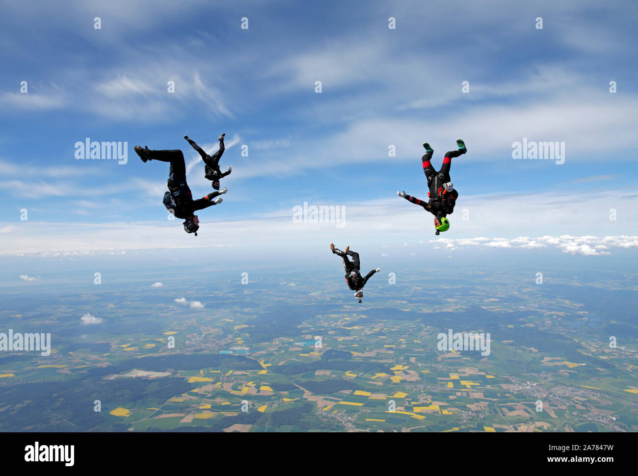 Skydivers are having fun together in the sky and are flying around each ...