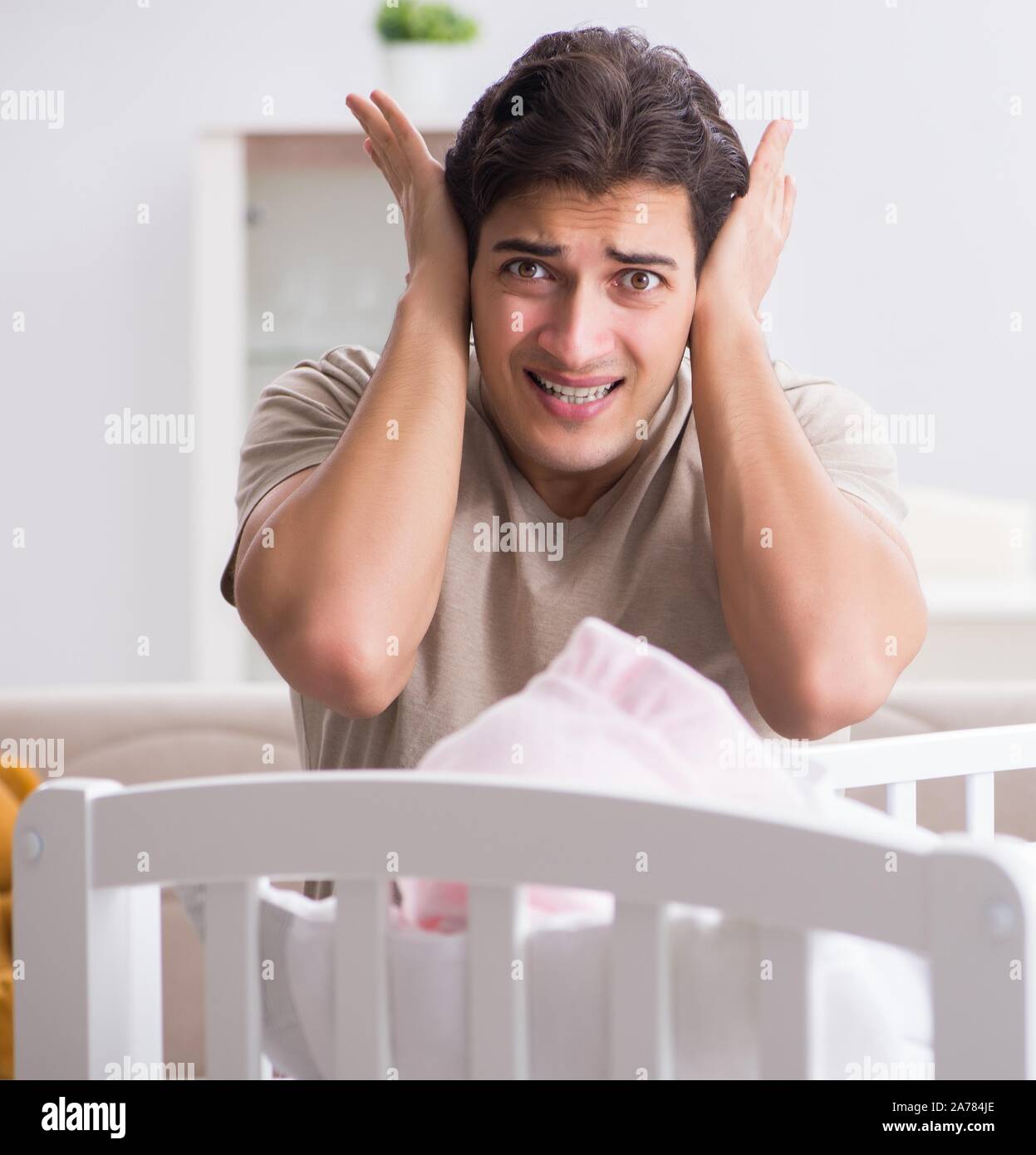 Young father dad frustrated at crying baby hi-res stock photography and ...