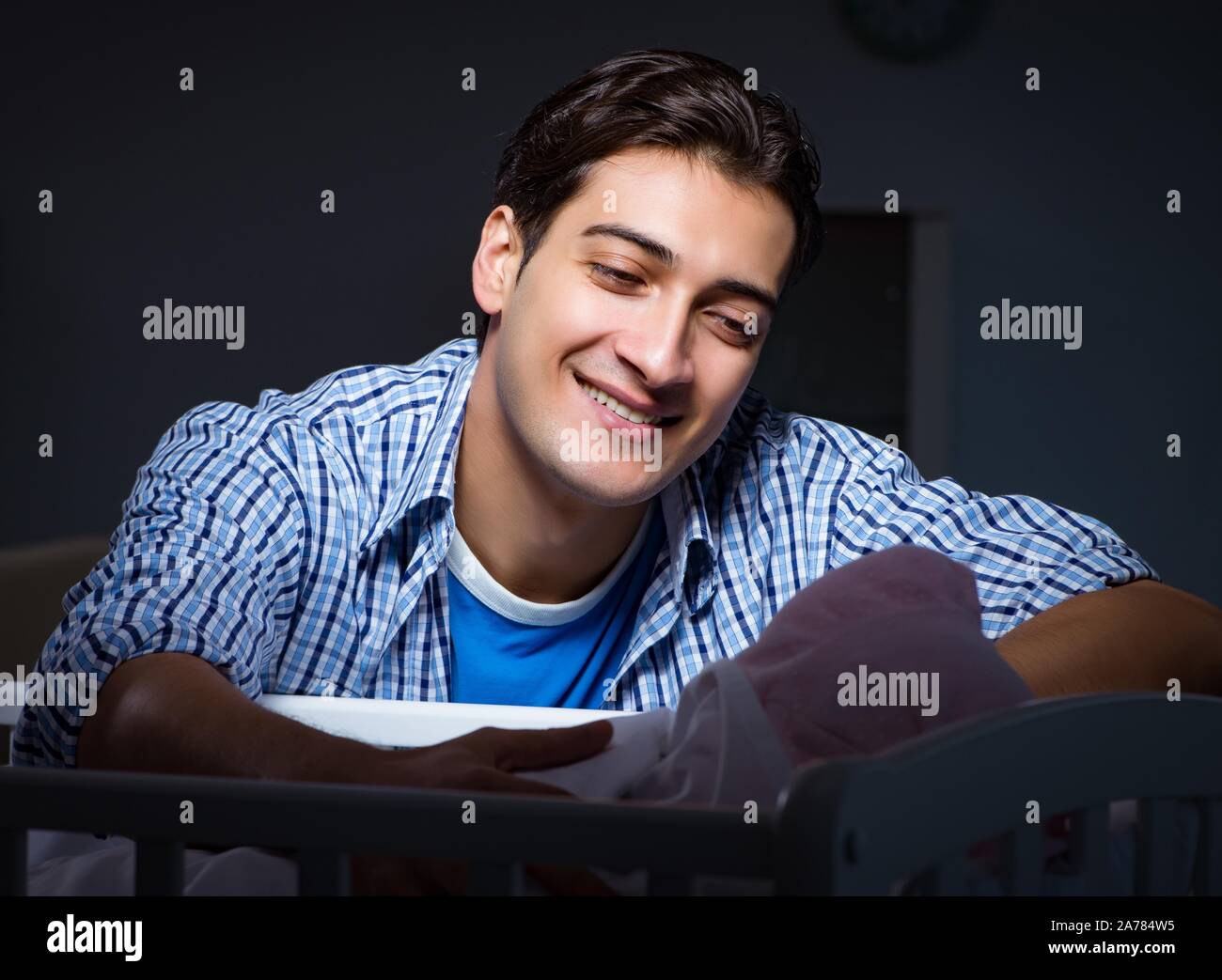 Happy dad looking after newborn baby at night Stock Photo - Alamy