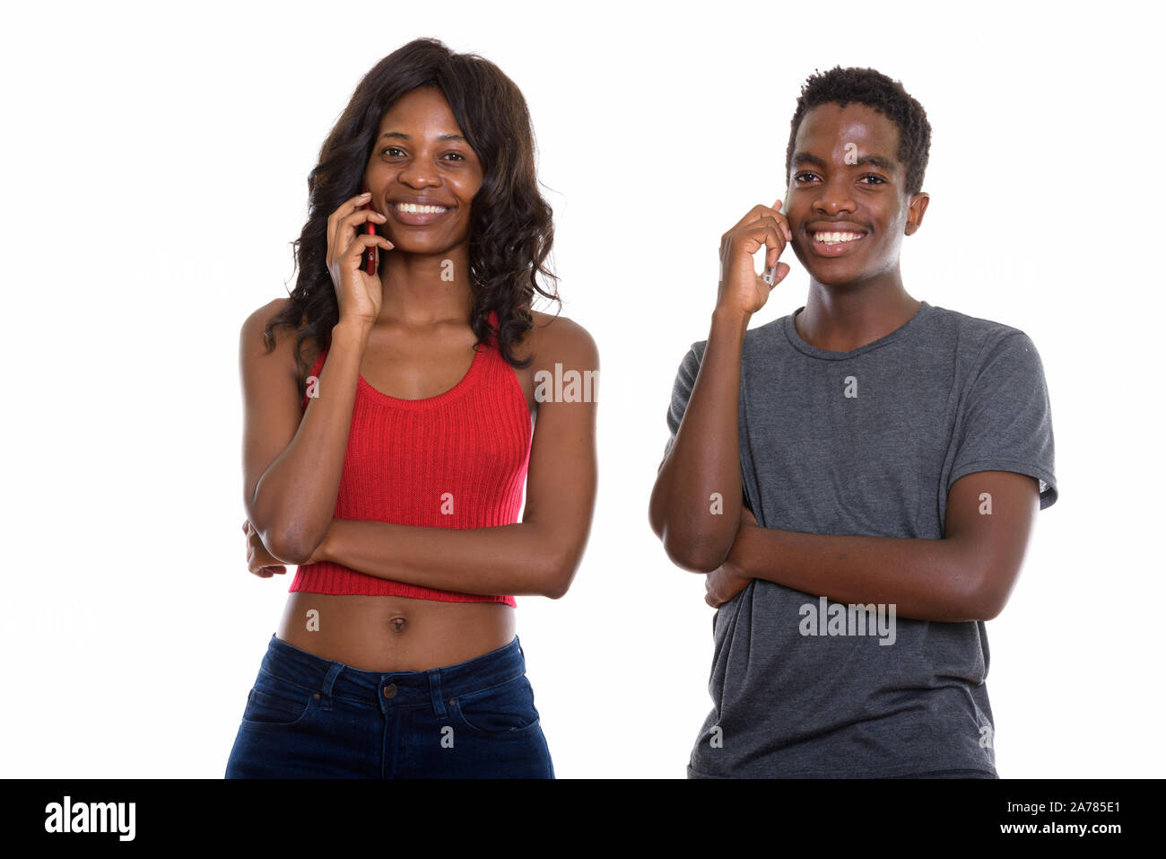 Studio shot of young African siblings using phone together Stock Photo ...