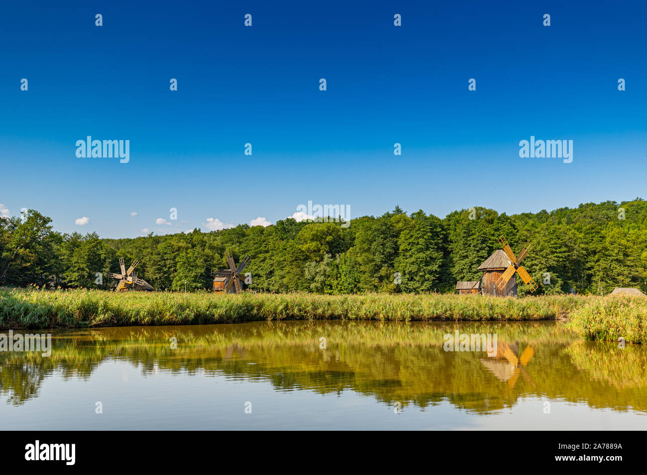 Windmill farm lake landscape. Windmill farm scene Stock Photo - Alamy