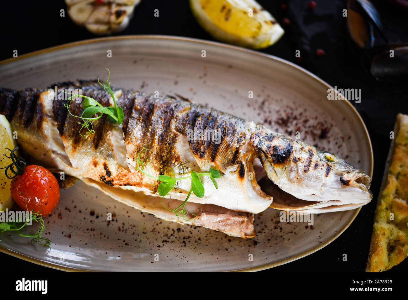 delicious grilled fish with lemon, salt & pepper Stock Photo - Alamy