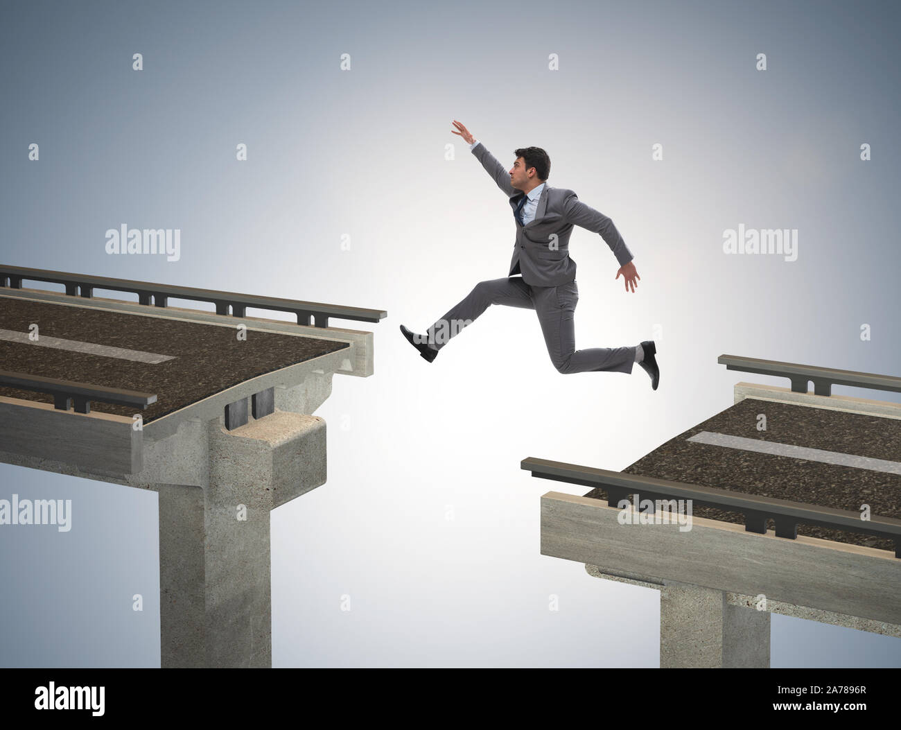 The young businessman jumping over the bridge Stock Photo - Alamy