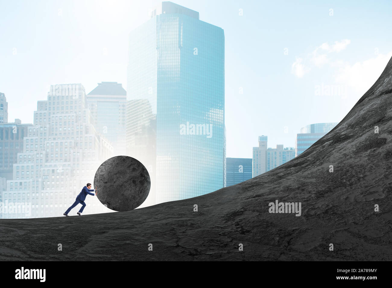 The man pushing large stone to the top Stock Photo - Alamy