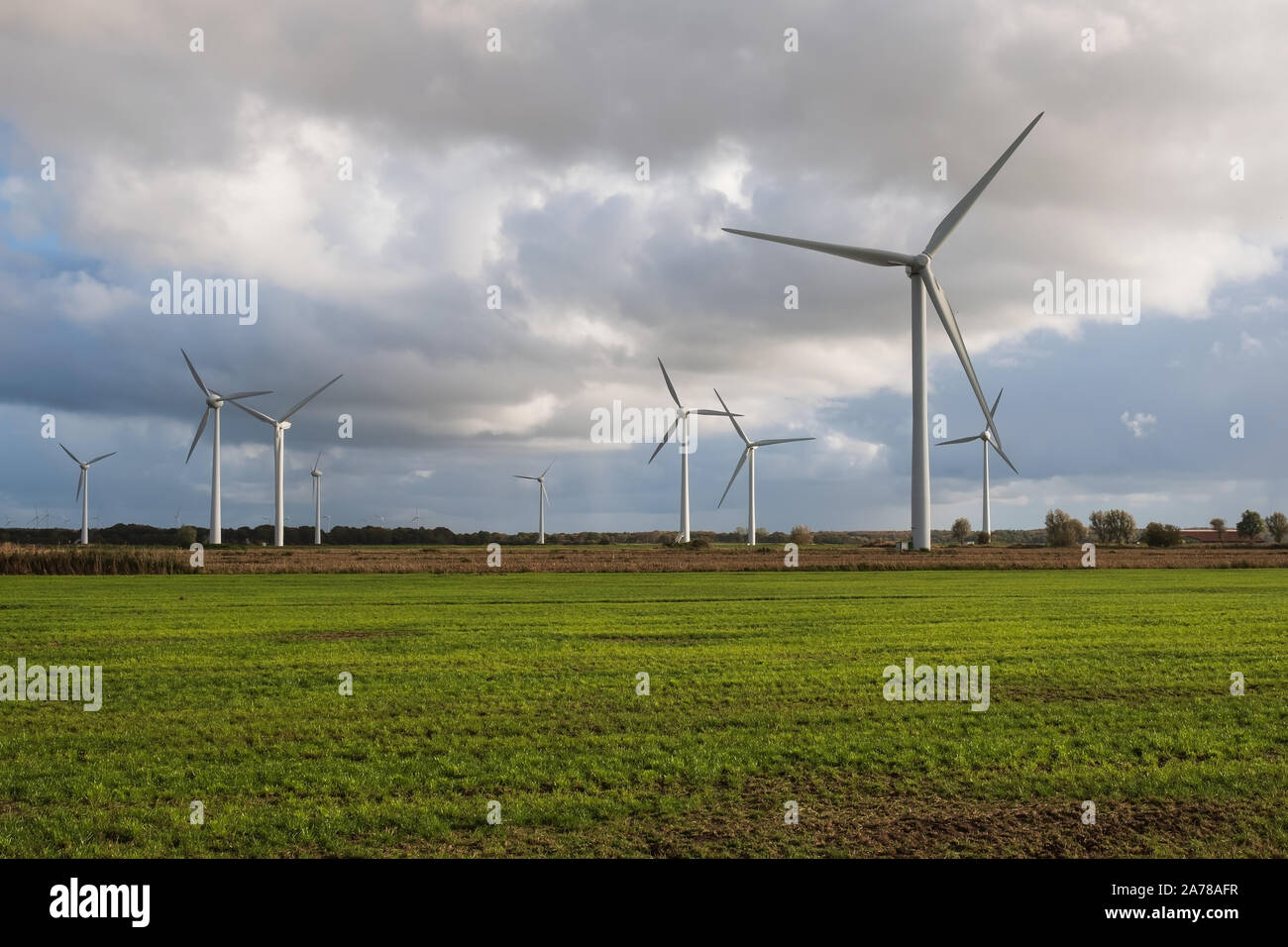 green field with wind turbines generating electricity in Germany Stock ...