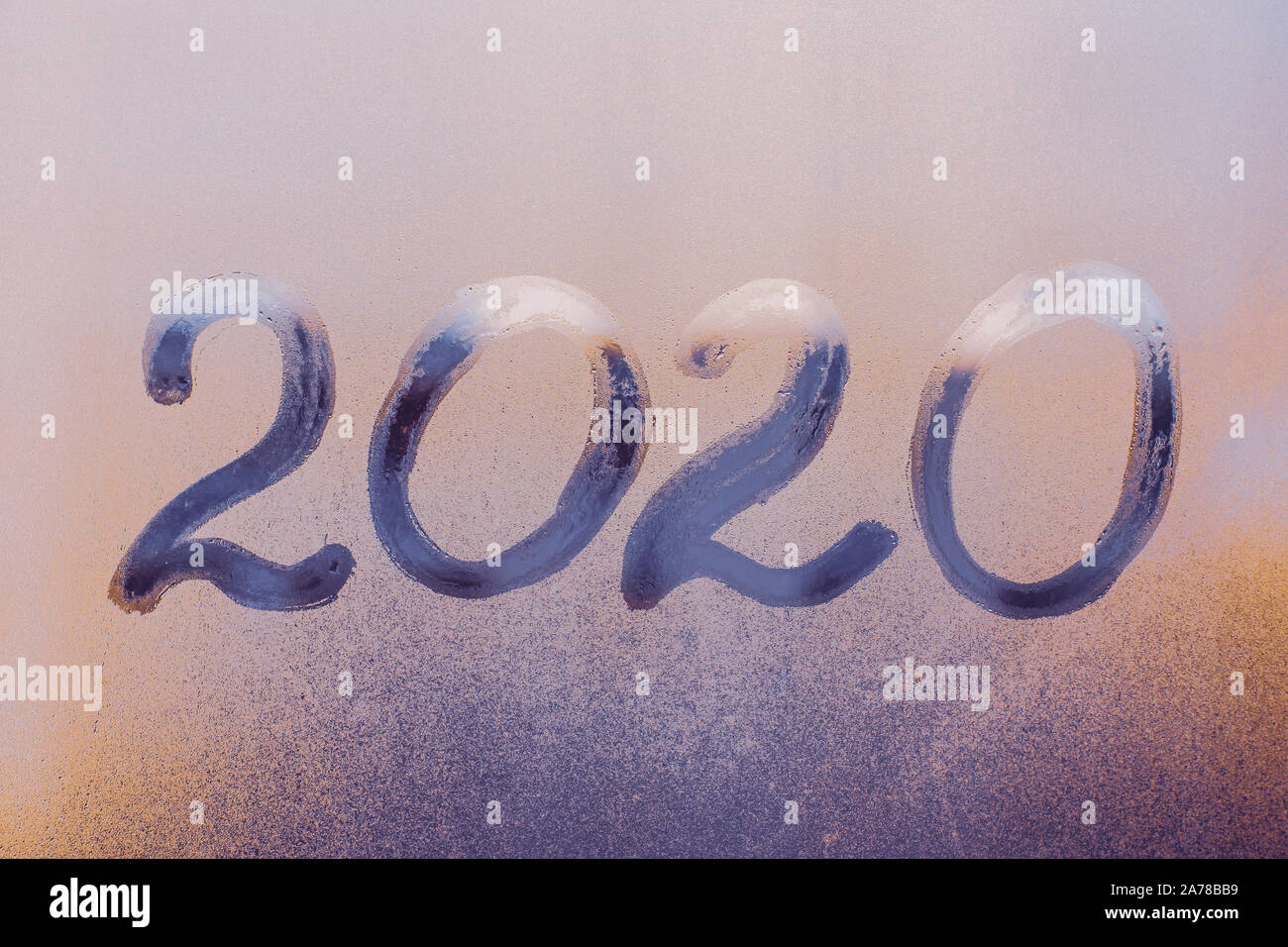 Inscription 2020 on foggy window. Handwritten text on wet glass. The ...