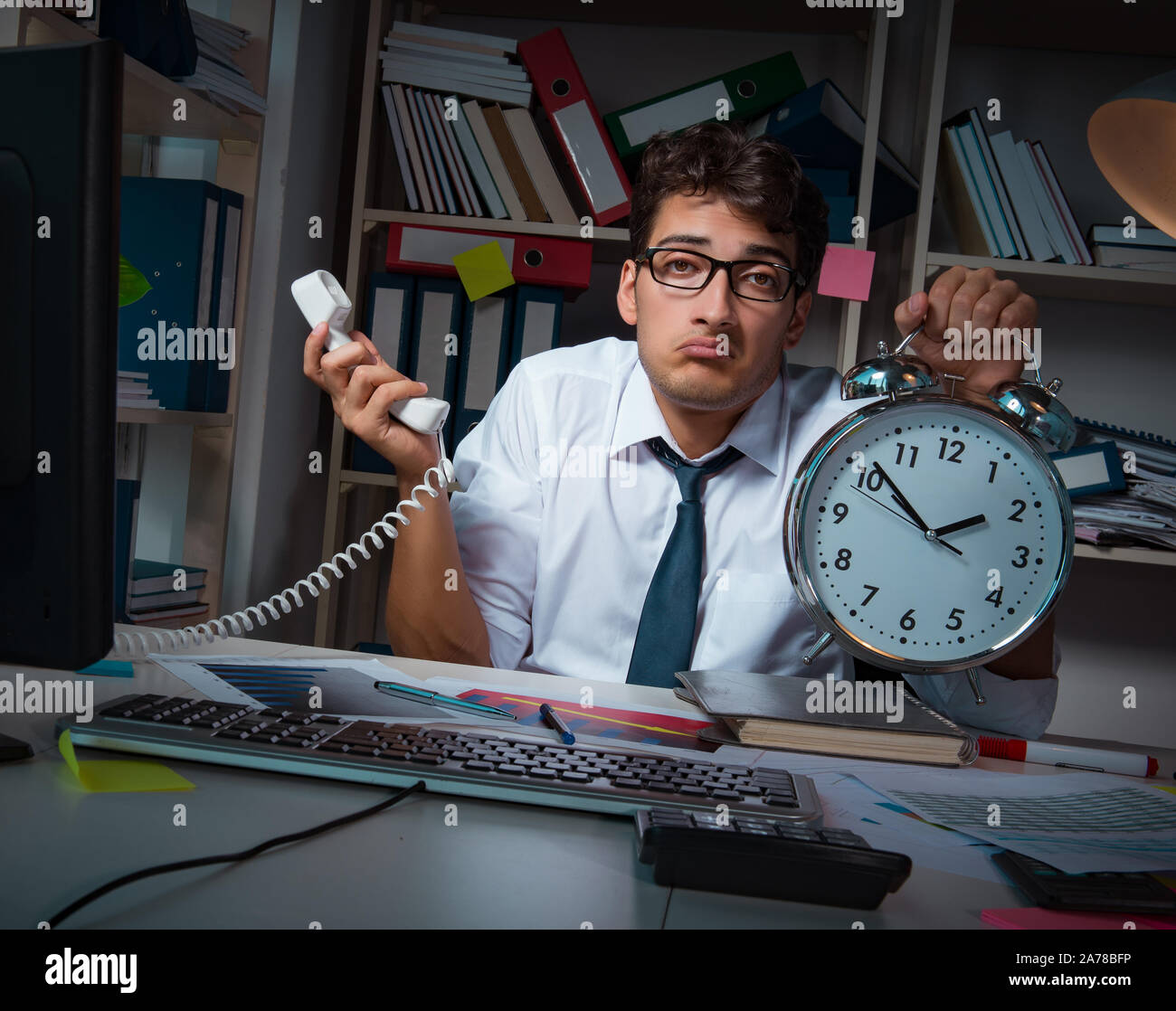 The man businessman working late hours in the office Stock Photo - Alamy