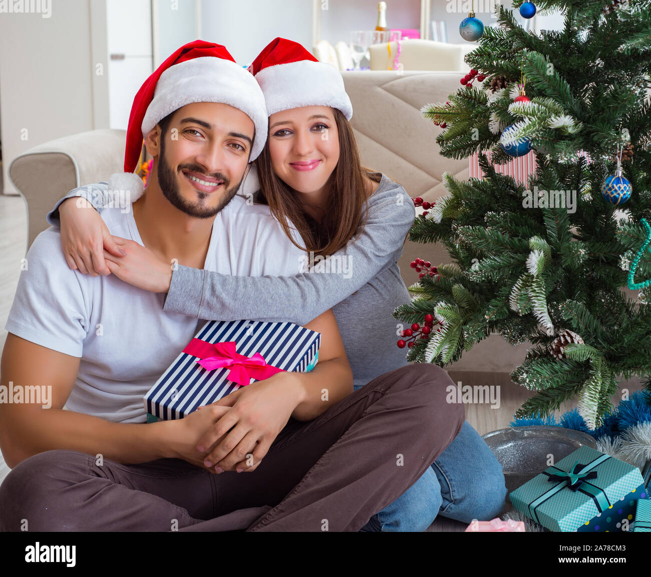 The girlfriend and boyfriend opening christmas gifts Stock Photo - Alamy