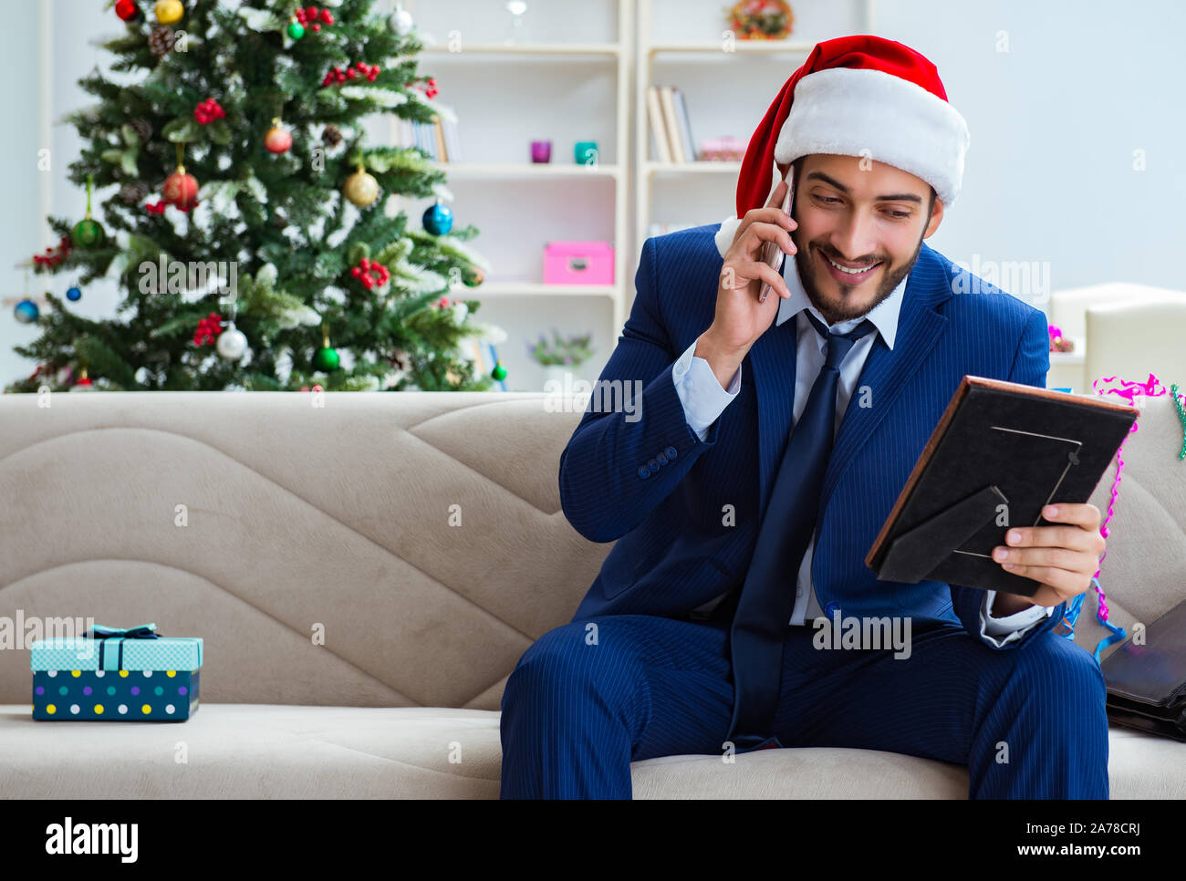 The businessman working at home during christmas Stock Photo - Alamy