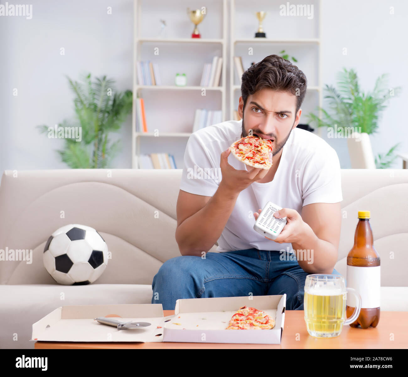The man eating pizza having a takeaway at home relaxing resting Stock ...