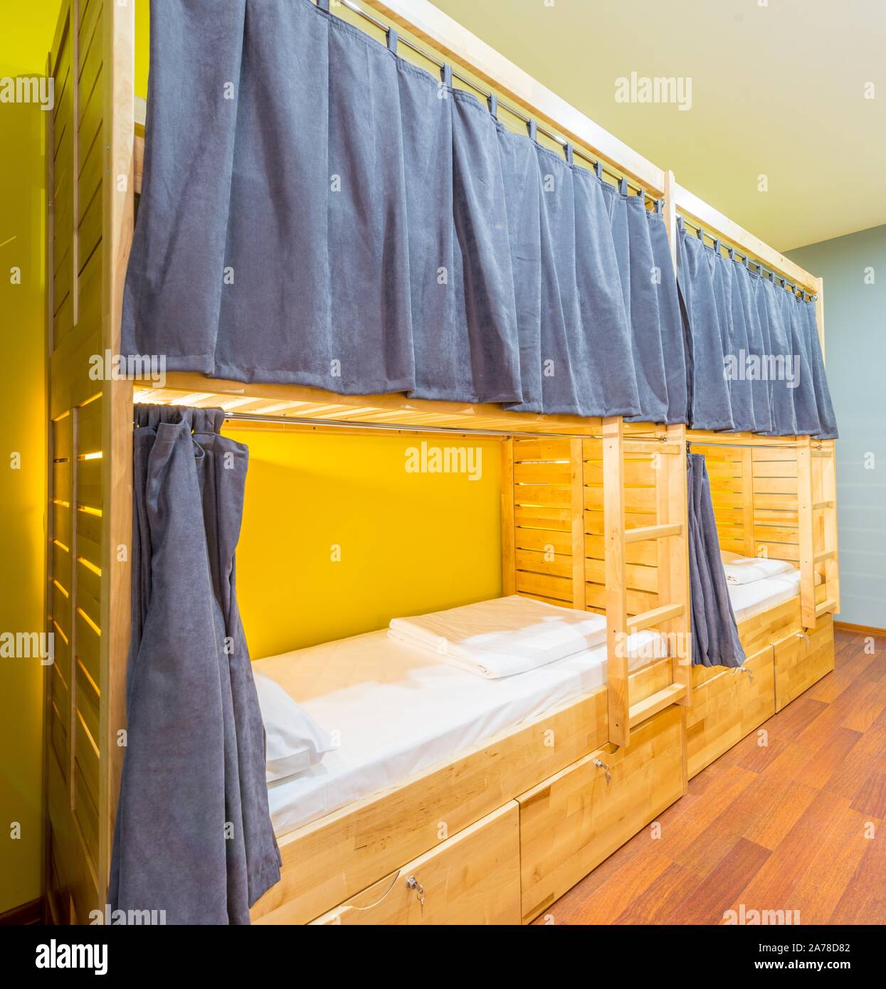 The hostel dormitory beds arranged in room Stock Photo - Alamy